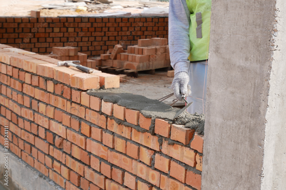 Brickwork by construction workers at the construction site. Workers ...
