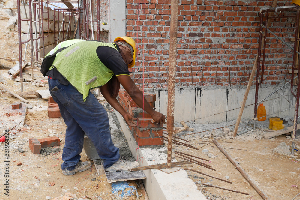Brickwork by construction workers at the construction site. Workers ...