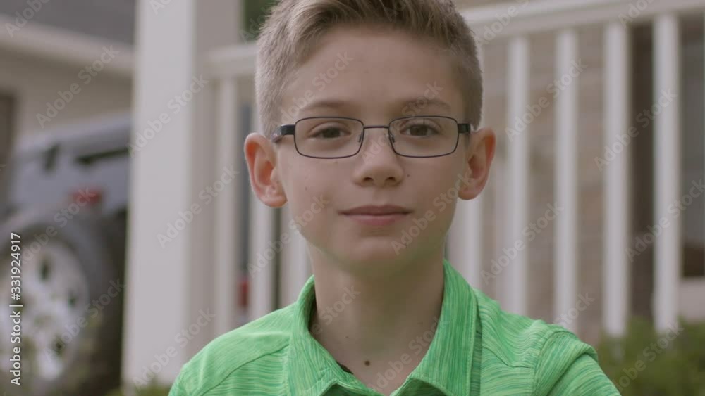 Low angle portrait of teen boy in front yard staring into camera. Stock ...