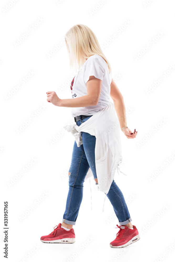 Side view of middle aged stressed woman rushing and walking in hurry ...