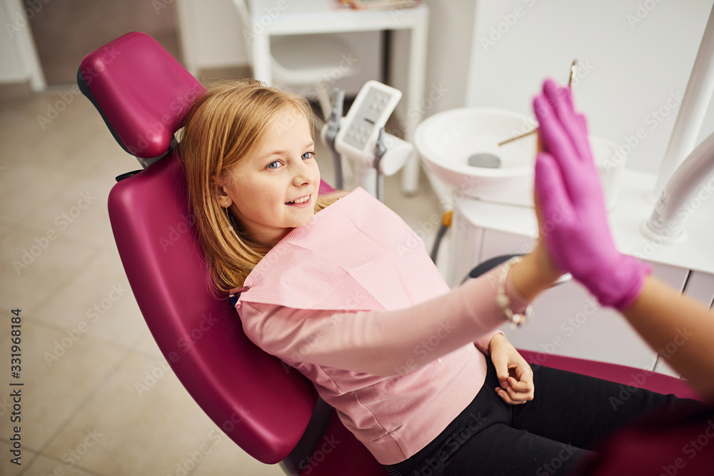 Gives high five. Little girl visiting dentist in clinic. Conception of ...
