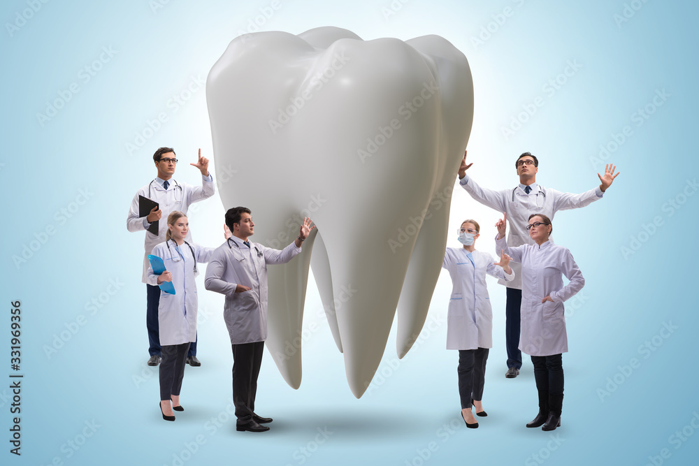 Doctors examining giant tooth in dental concept Stock Photo | Adobe Stock