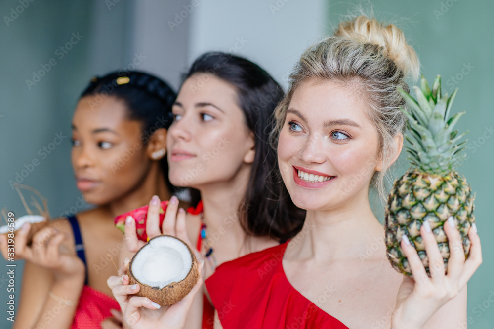 Beautiful young women in swimsuits, with tropical fruits and cocktail ...