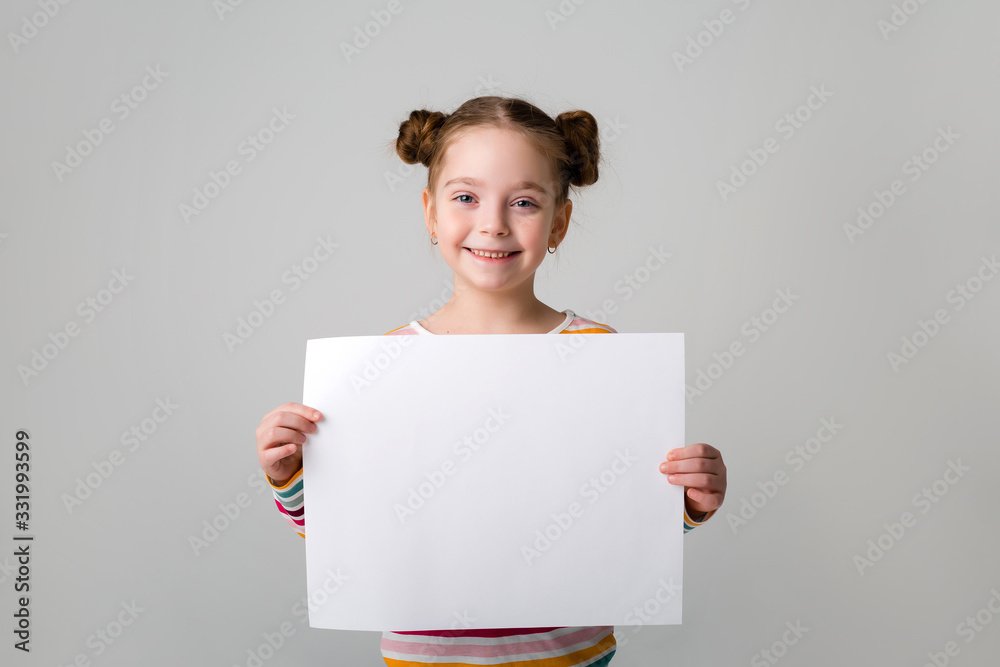 baby girl holding a white sheet.Cute little girl with a white sheet of ...