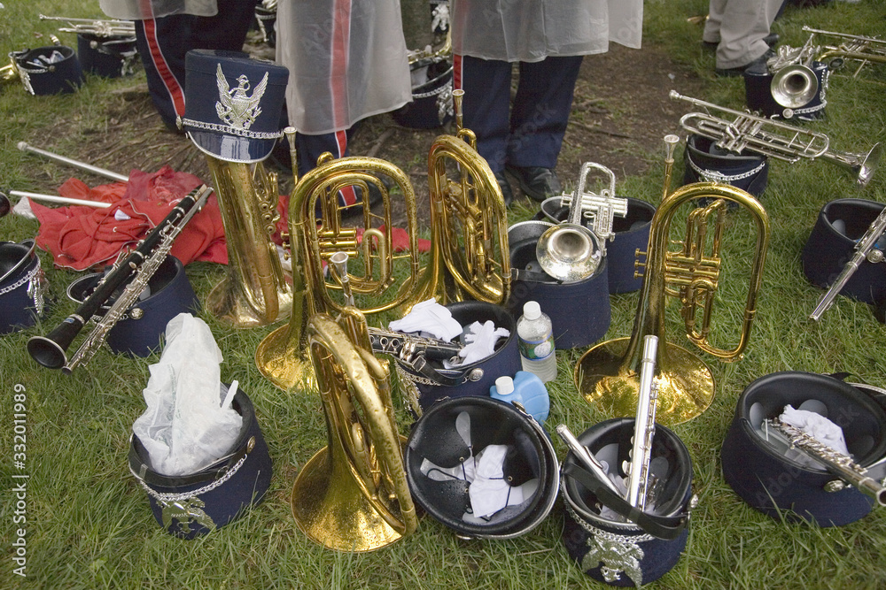 Marching band instruments standing on wet grass during rain storm ...