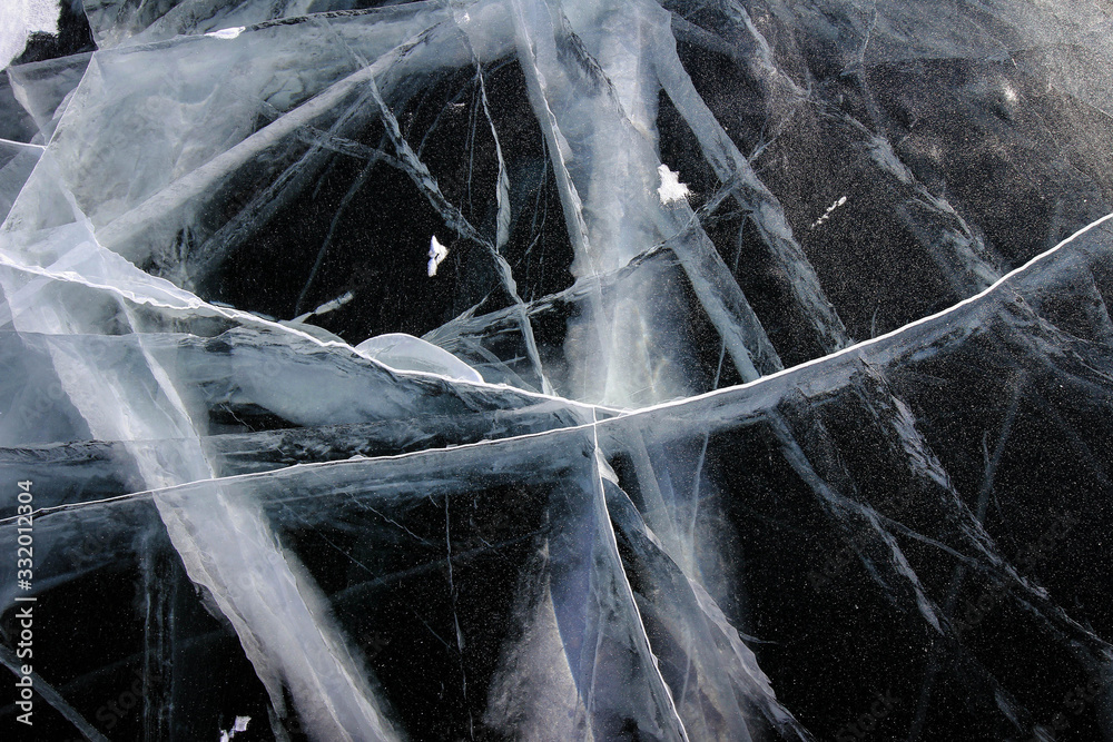 Ice pattern view with breaks and bubbles, frozen Baikal Lake, Russia ...