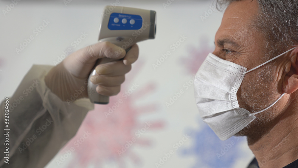 Taking man 's temperature with thermometer to find infected by ...