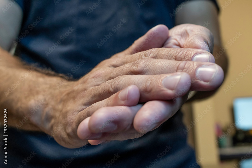A tan hairy arm person rubs the sanitizer on their hands to kill any ...