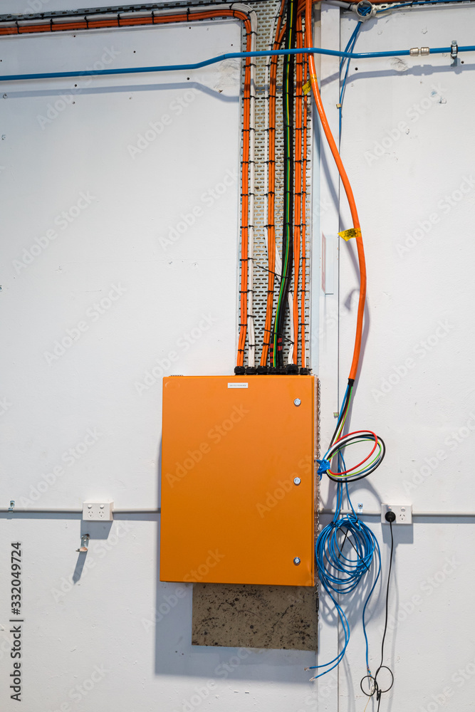 Orange cabinet and power distribution board with cabling mounted on ...