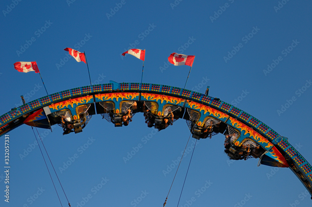 Riders hanging upside down on a roller coaster ride at the CNE Toronto ...