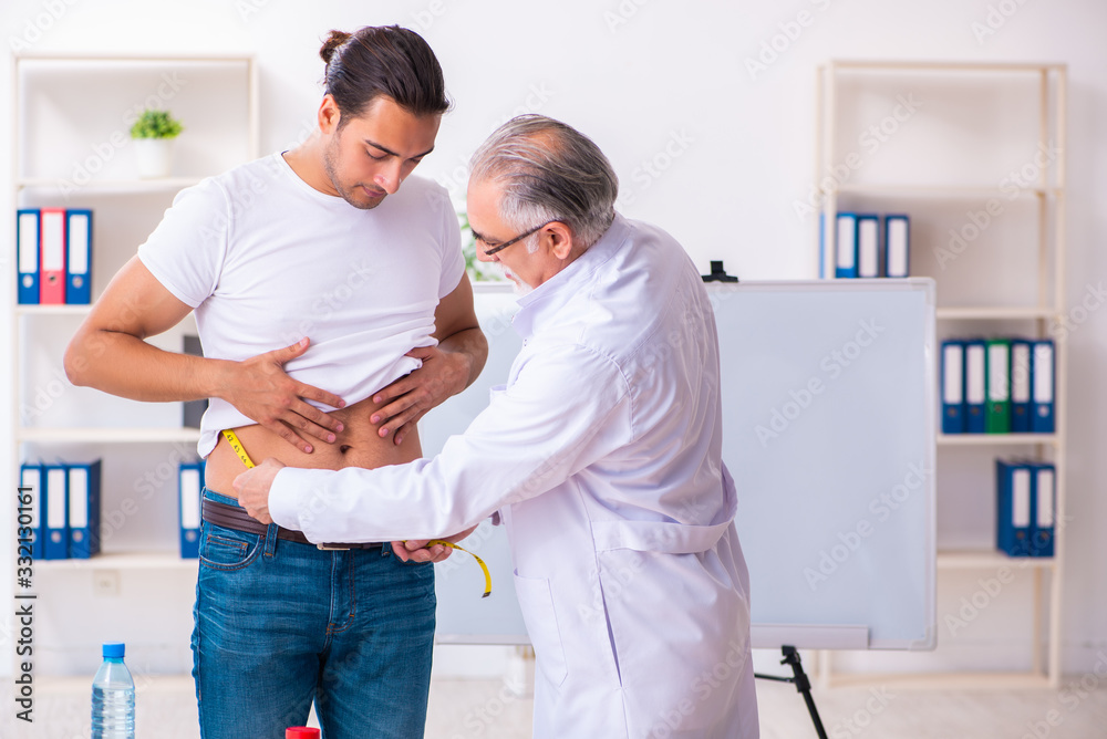 Doctor dietician giving advices to fat overweight patient Stock Photo ...