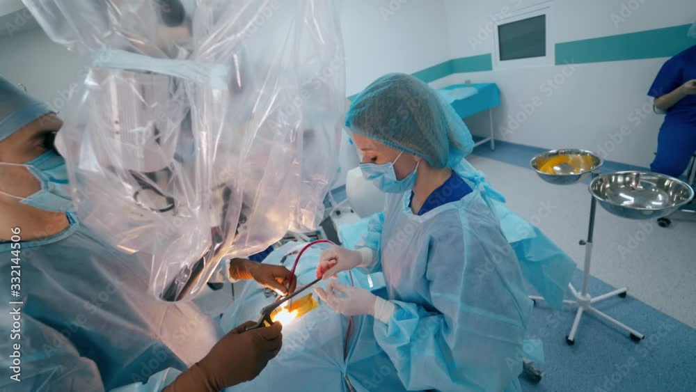 Modern operating room of surgical procedure to patient. Assistant ...