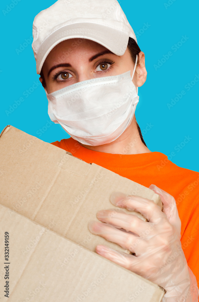 Delivery girl wears medical face mask and gloves and holds two boxes ...