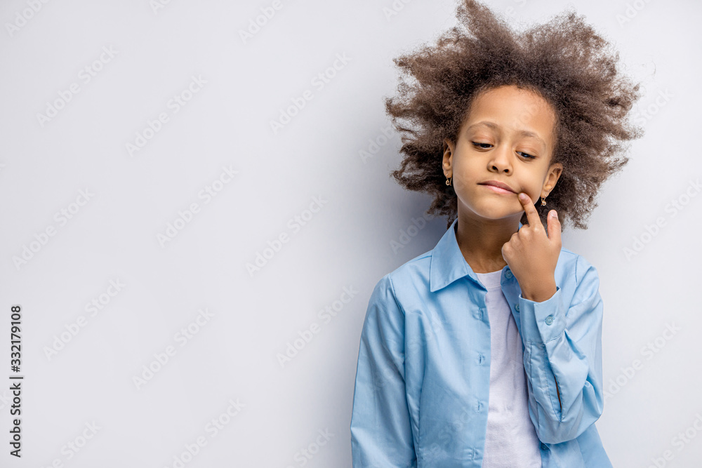 portrait of child pulling smile on her face. sad, unhappy child look ...