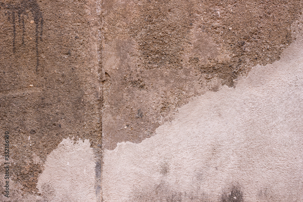 Gray and brown wall ruined by time, bad weather and humidity. Paint and ...