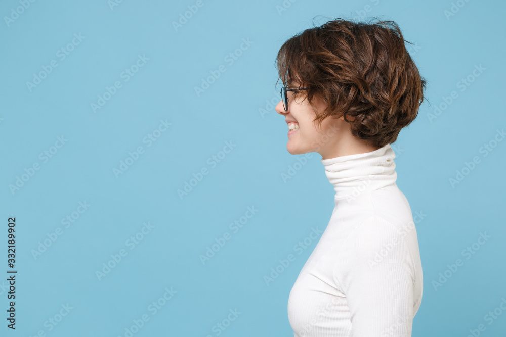 Side view of smiling young brunette woman girl in casual white clothes ...