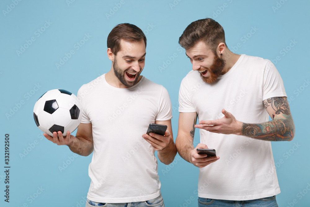 Excited men guys friends in white t-shirt isolated on pastel blue ...