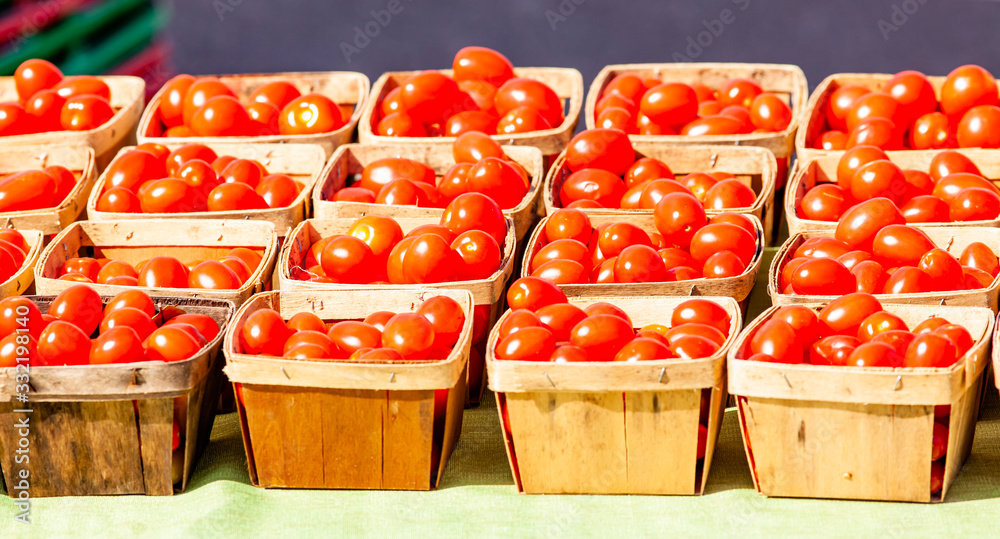 Baskets of tomatoes are on display at a local farmers market Stock ...