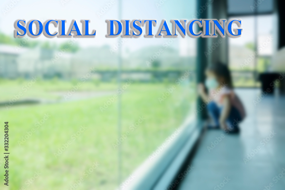 Social Distancing text on de-focused child wearing mask alone ...