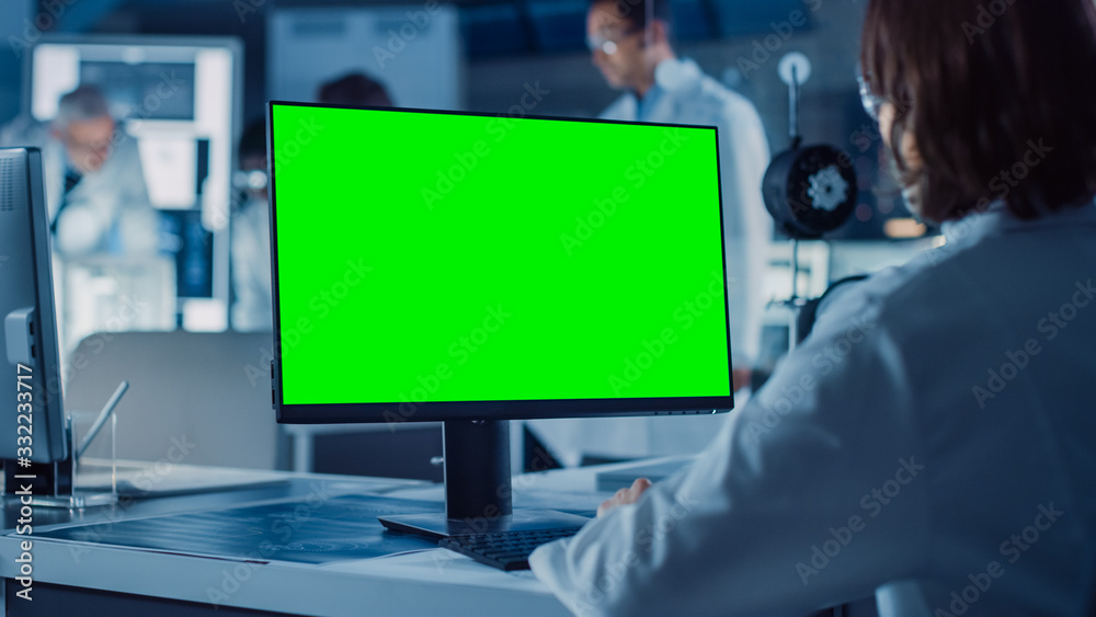 Over the Shoulder Shot: Female IT Scientist Uses Green Mock-up Screen ...