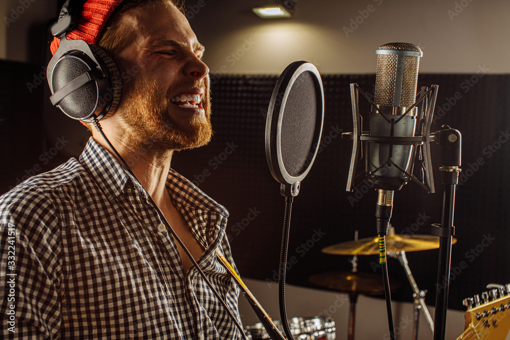 professional caucasian singer man sing in recording studio. handsome ...