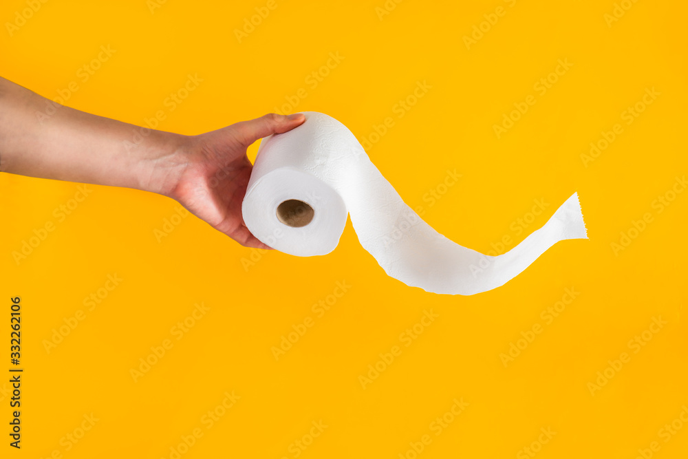 Close up caucasian male hand holding or giving a roll of toilet paper ...