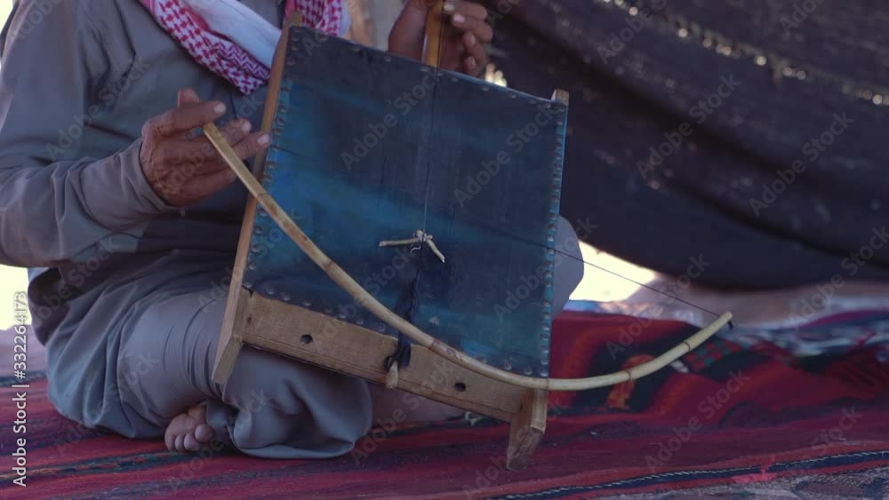 Stockvideo Bedouin Man in Traditional Dress, Playing a Traditional ...
