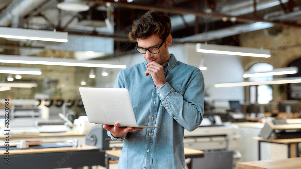 Hard work never hurt. Young businessman posing in office Stock Photo ...