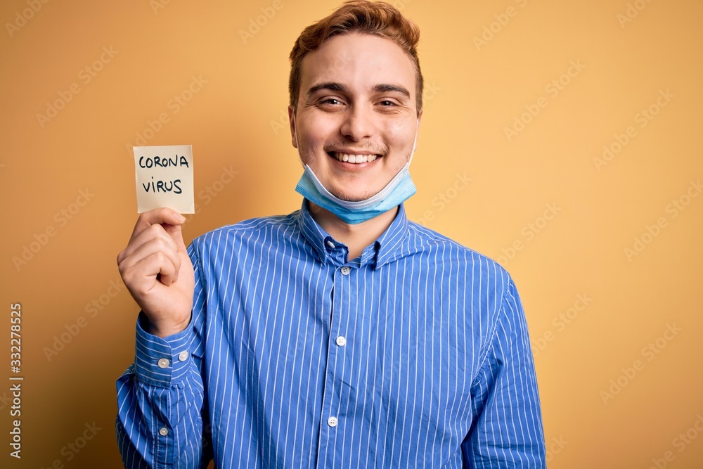 Young man wearing medical security mas holding paper note reminder with ...