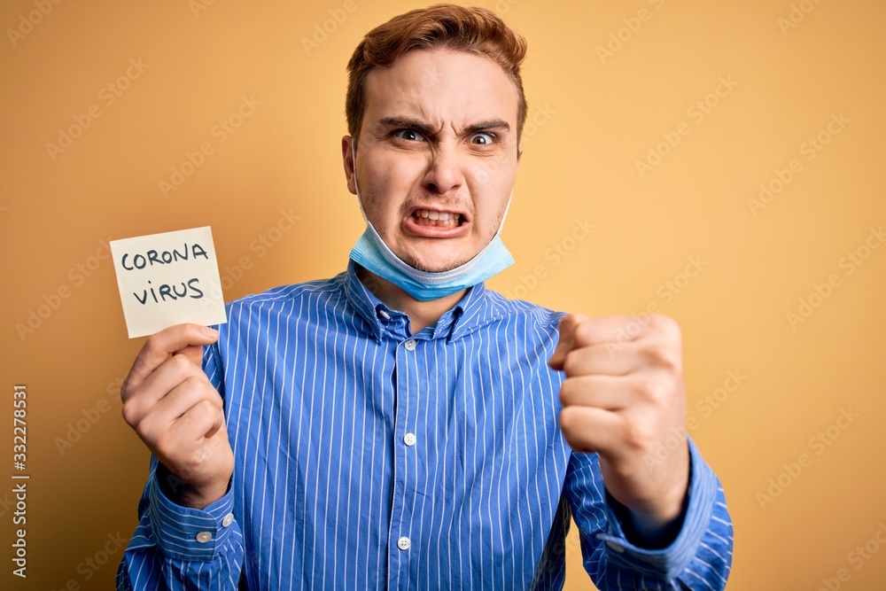 Young man wearing medical security mas holding paper note reminder with ...