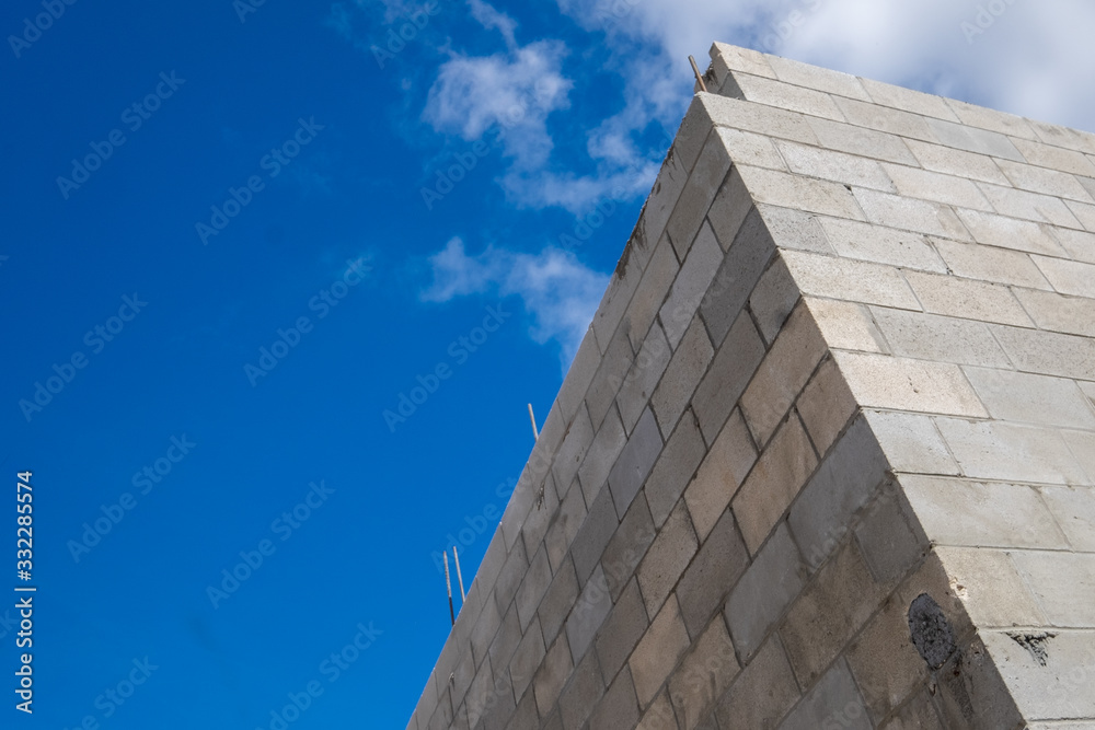 The corner upward view of an exterior wall of a concrete block building ...