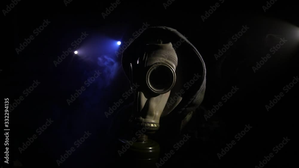 Environmental disaster. Post-apocalyptic survivor in gas mask on a dark ...