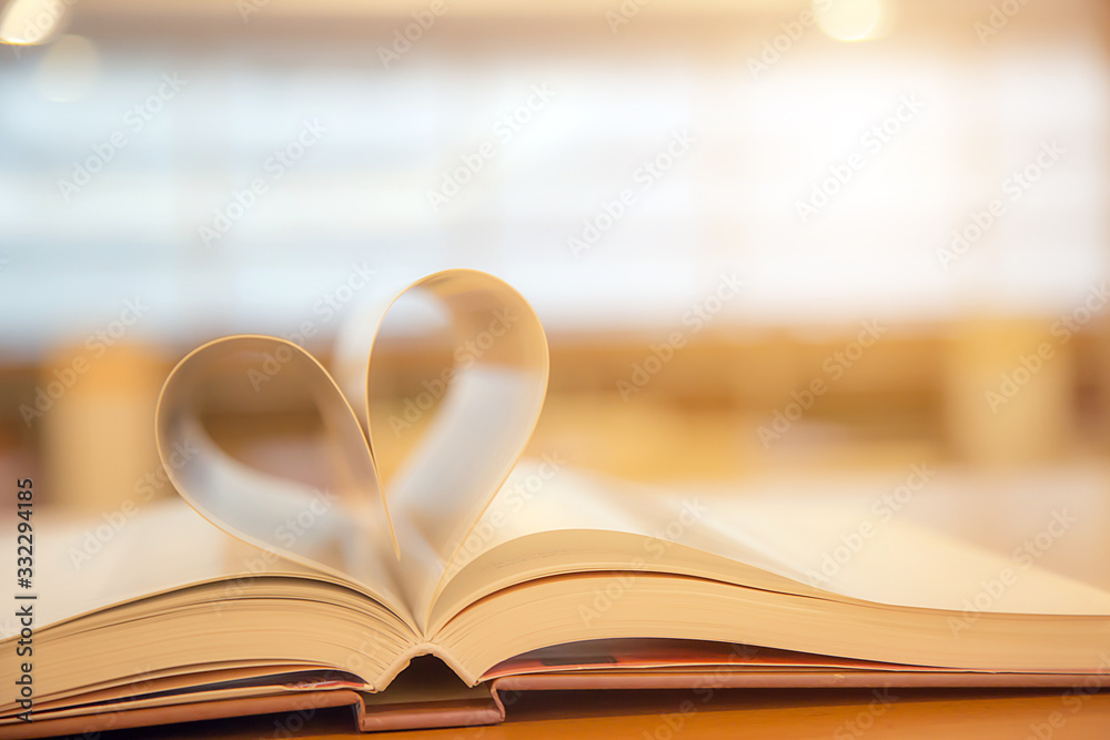 Book in heart shape on desk at library for reading education learning ...