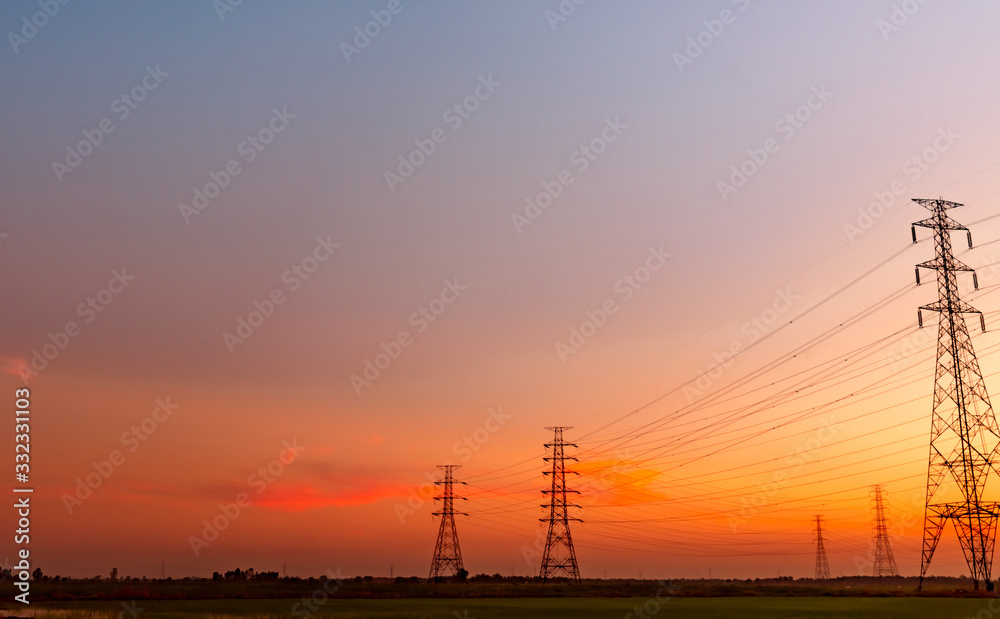 High voltage electric pylon and electrical wire with sunset sky ...