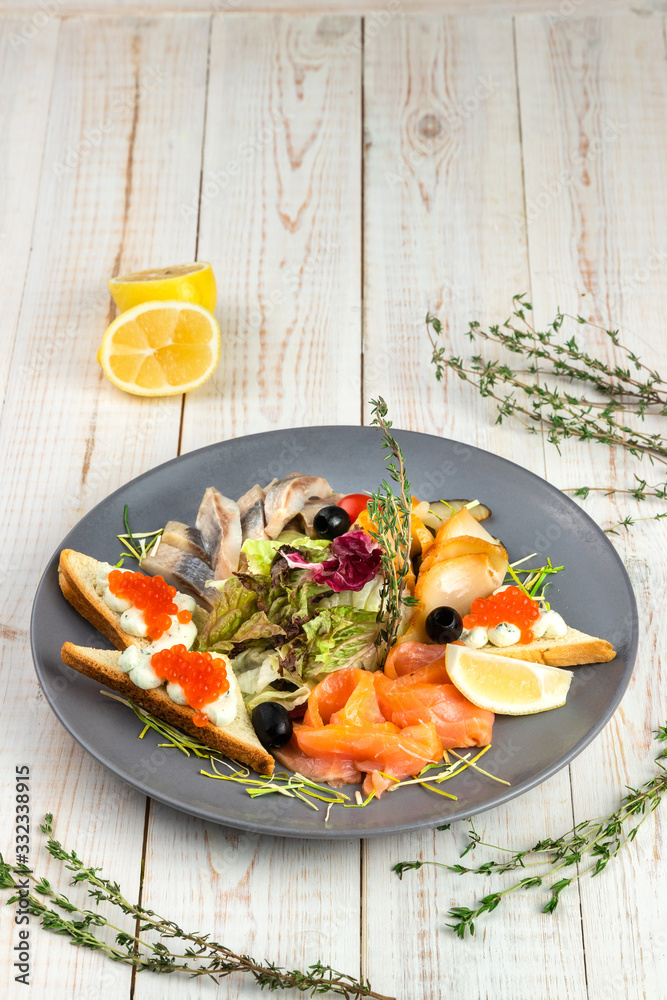 appetizer with smoked salmon, butterfish and herring, wheat croutons ...