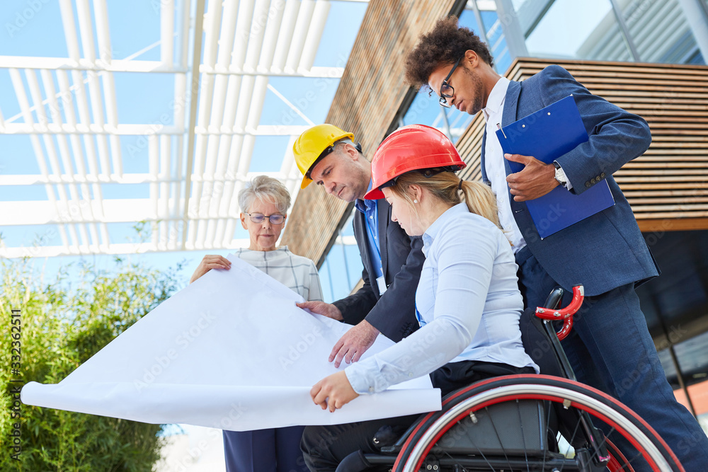 Disabled architect in a wheelchair and engineers Stock Photo | Adobe Stock