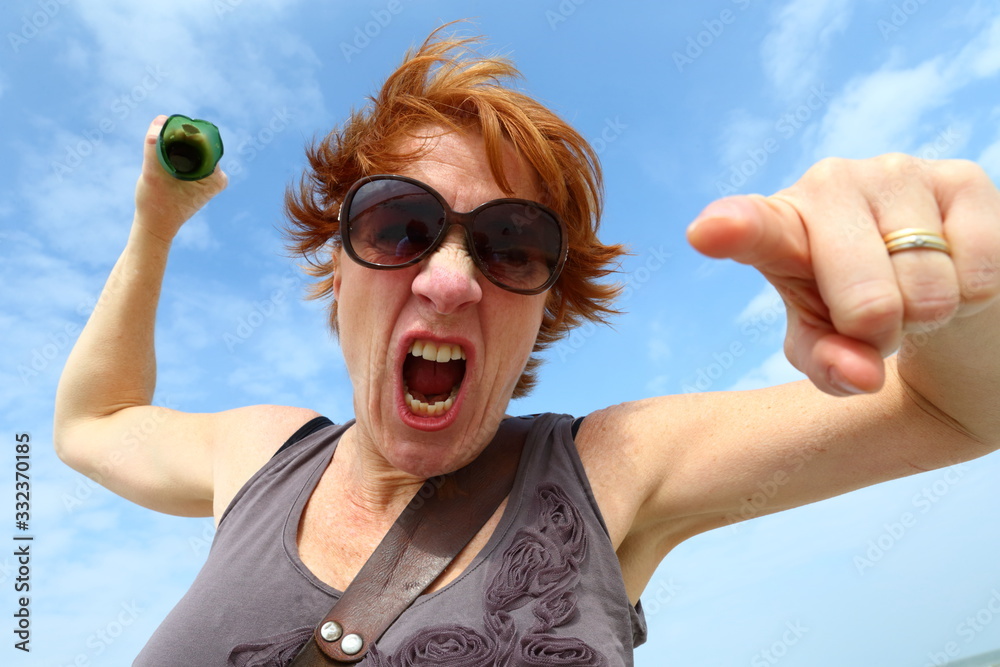 agressive woman shouting and threatening to stab with a broken beer ...