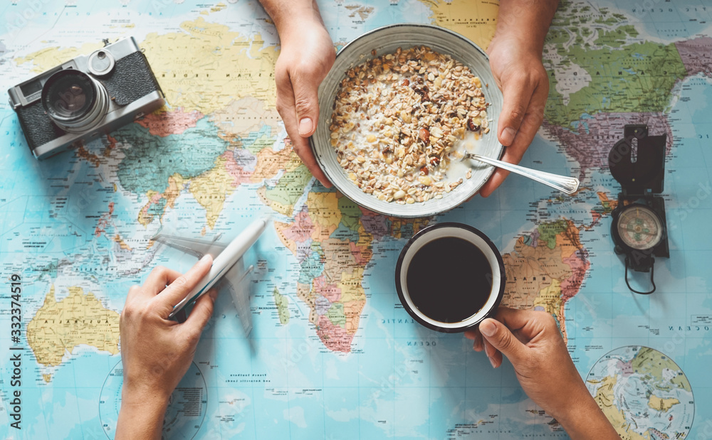 Top view hands people planning vacation with world map while doing ...