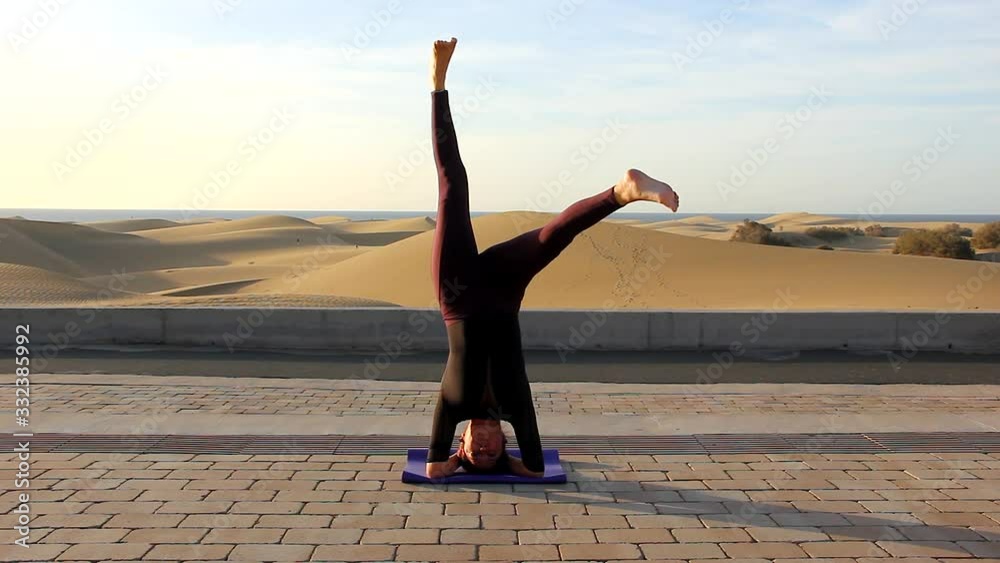 Video „Young woman in ardha parsvaikapada sirsasana on mat by ...