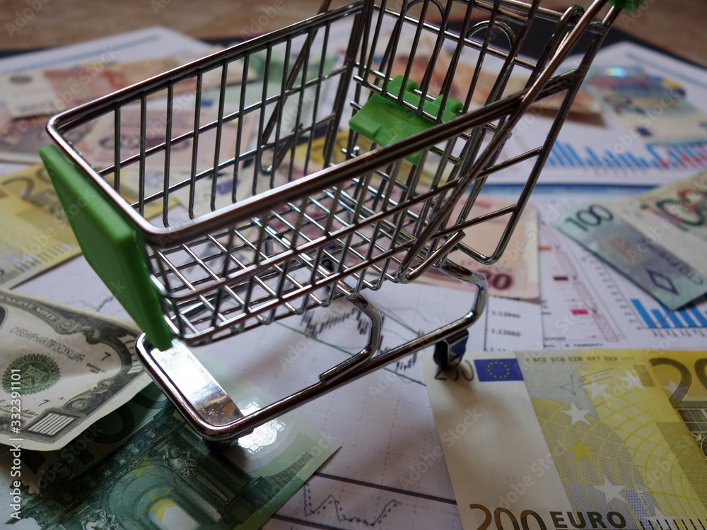 empty consumer basket against the background of financial charts and ...
