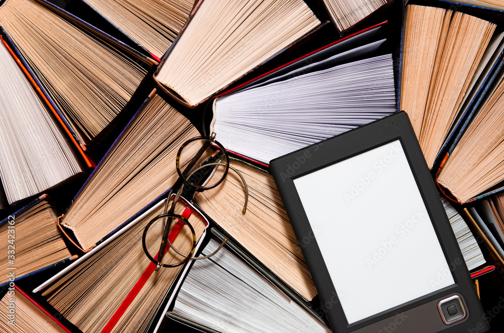 The e-book with a clean white screen rests on the open multi-colored ...