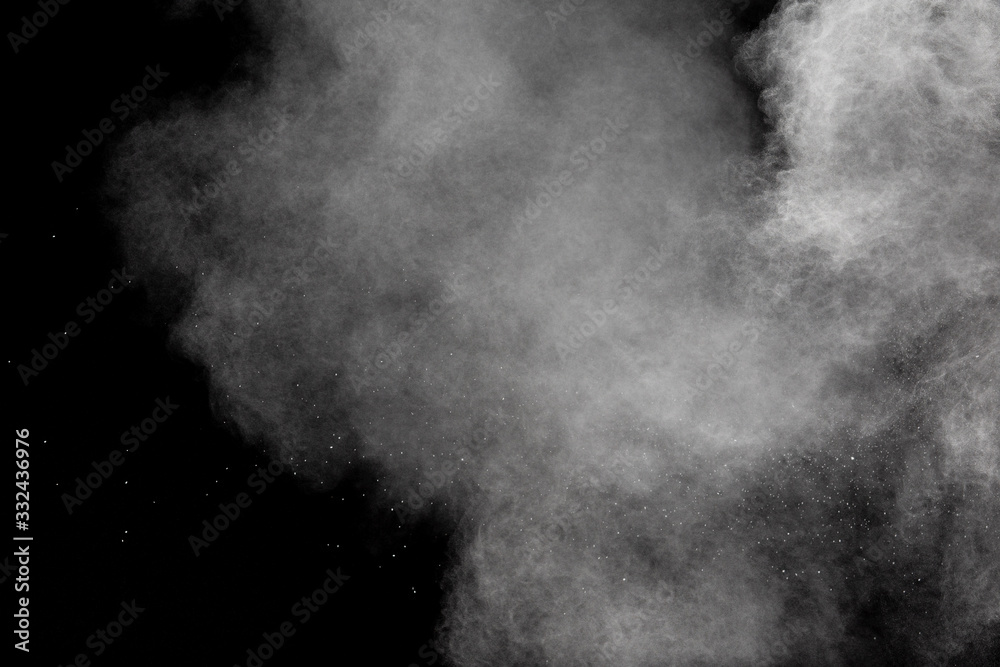 Abstract white powder explosion against black background.White dust ...