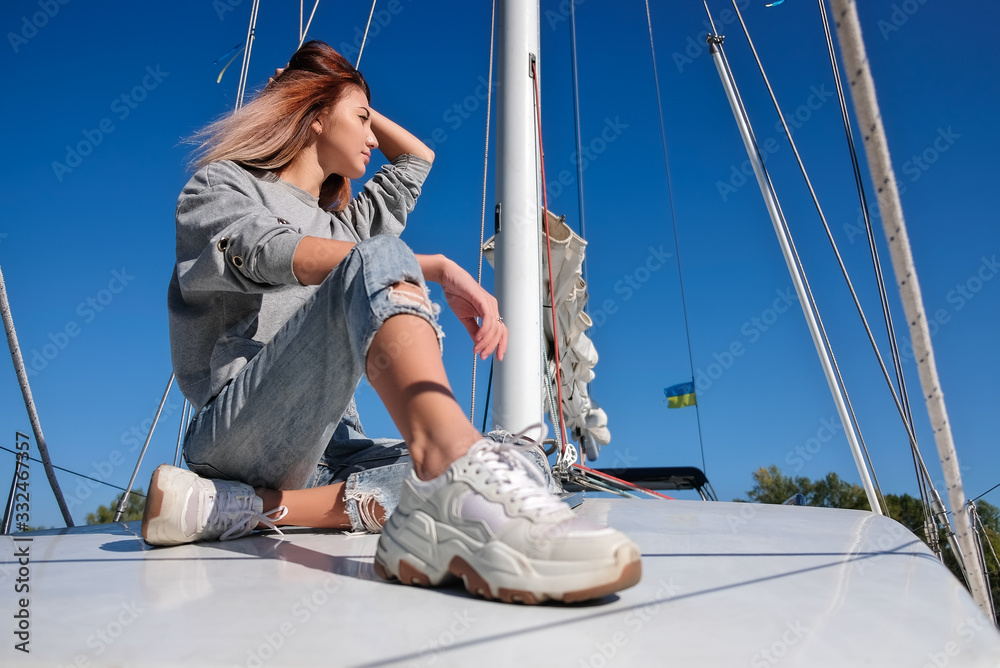 Beautiful young woman posing on yacht. Model is sailing on board. Stock ...