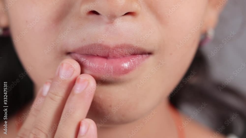 Extreme close up of child touch's her mouth - concept showing to ...