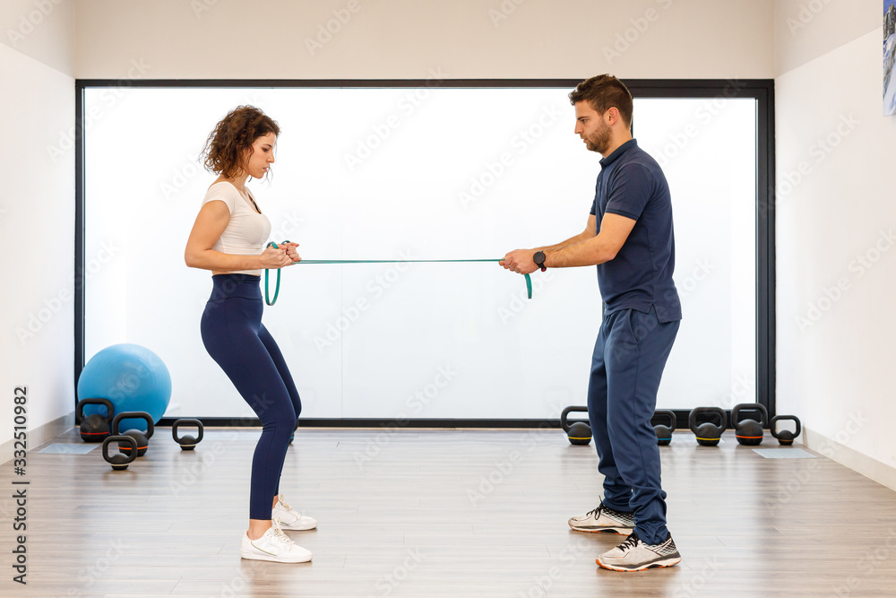 Side view of male and female athletes in active wear standing in front ...