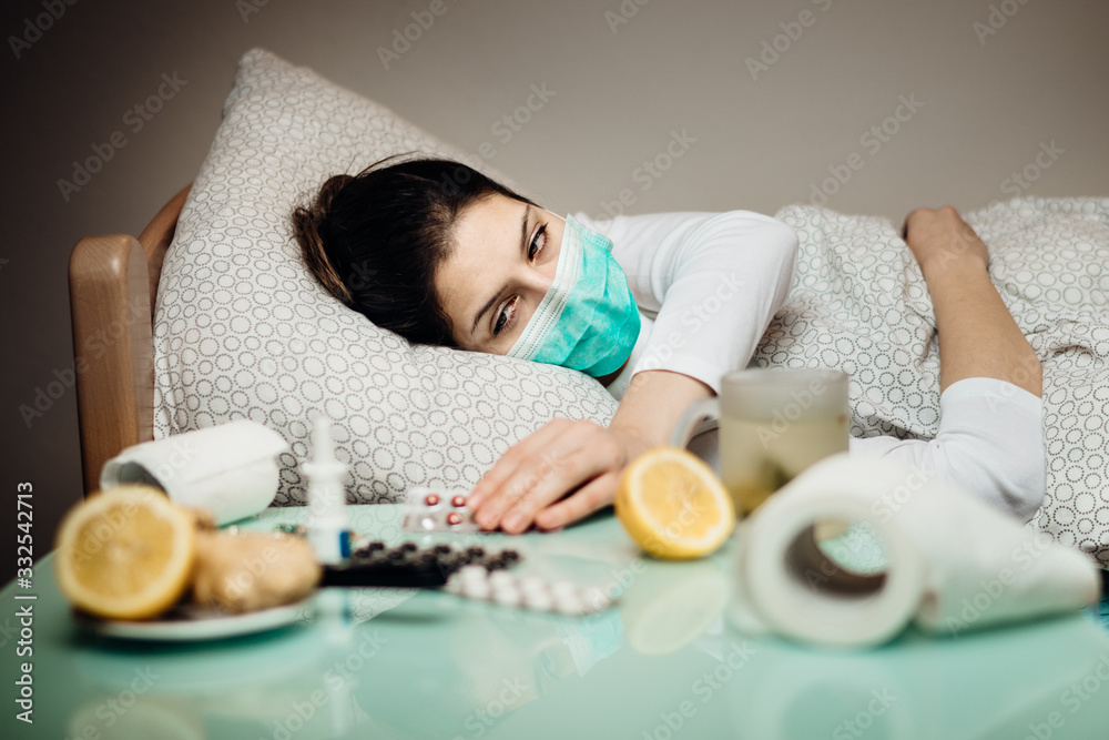 Sick woman with mask in quarantine bed self isolation.Coronavirus Covid ...