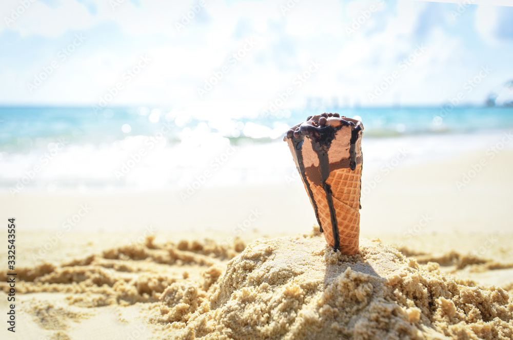 Ice cream cone on sand beach background - Melting ice cream on beach ...