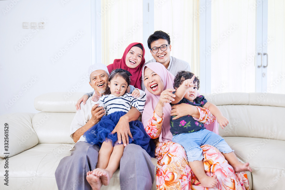 Three generations of muslim family smiling at camera Stock Photo ...