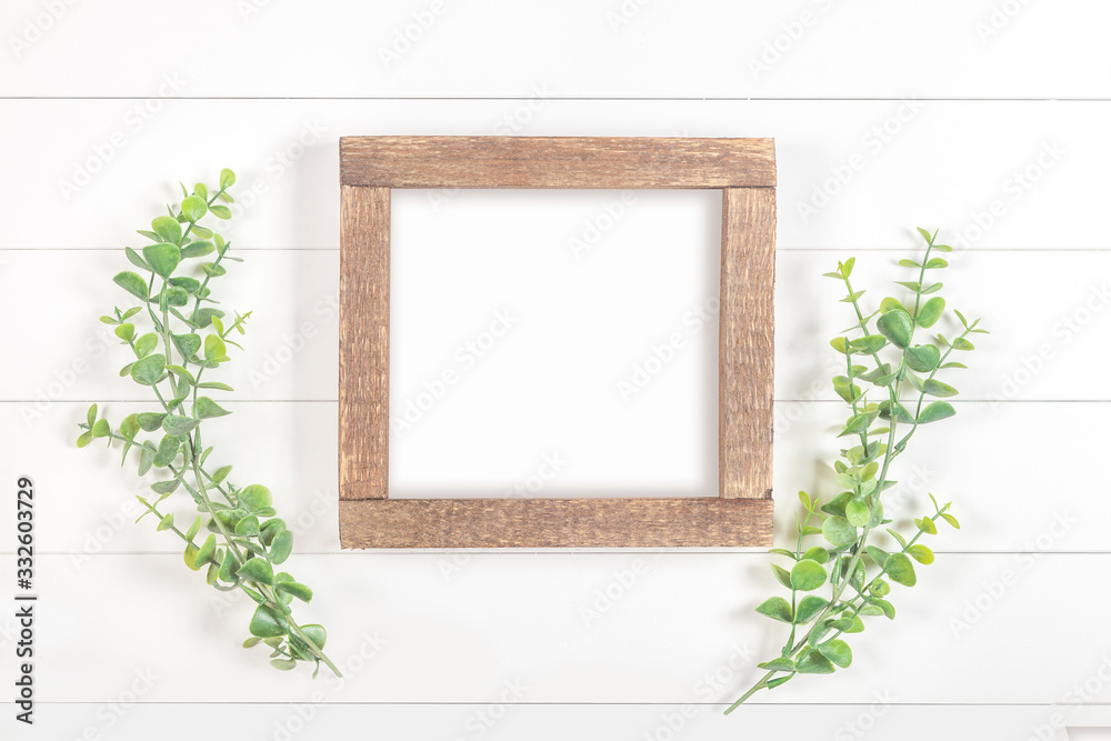 Rough wood square frame on a white background with green branches Stock ...