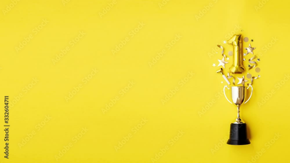 Number 1 gold anniversary celebration balloon exploding from a winning ...